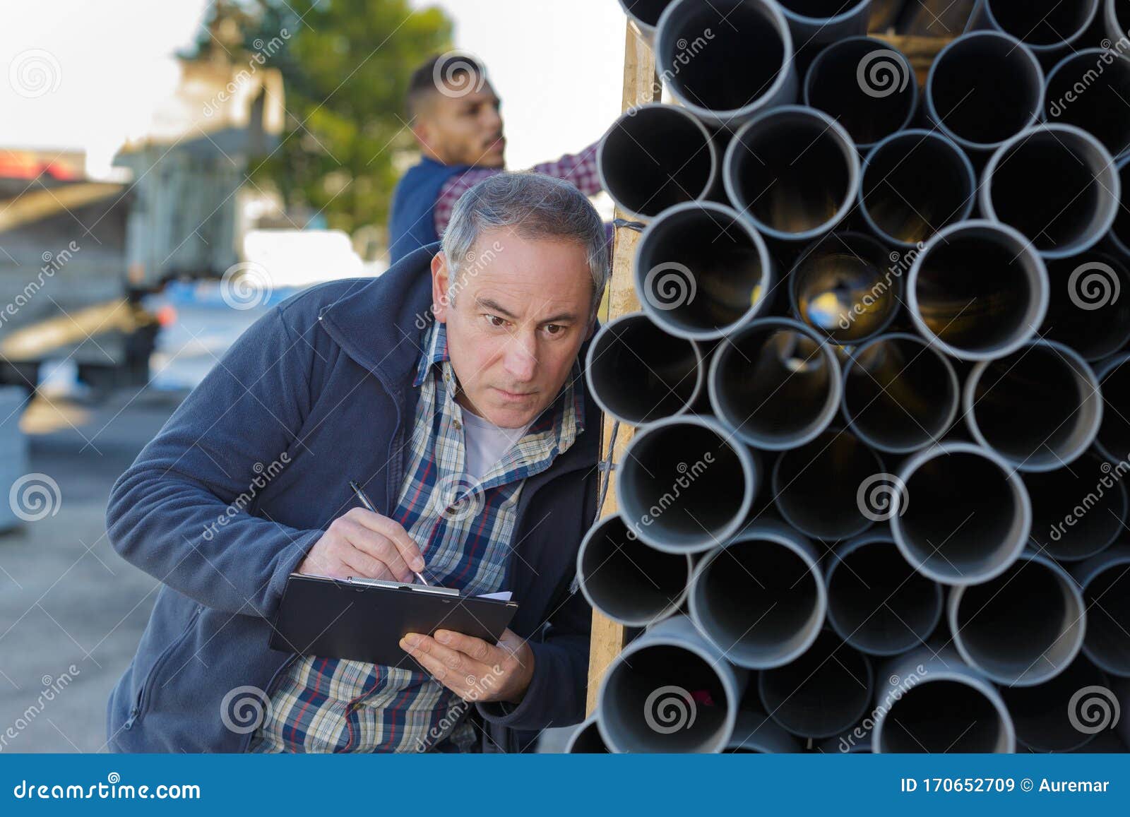 Workers Inspecting Pipes in Yard Stock Image - Image of pipeline ...