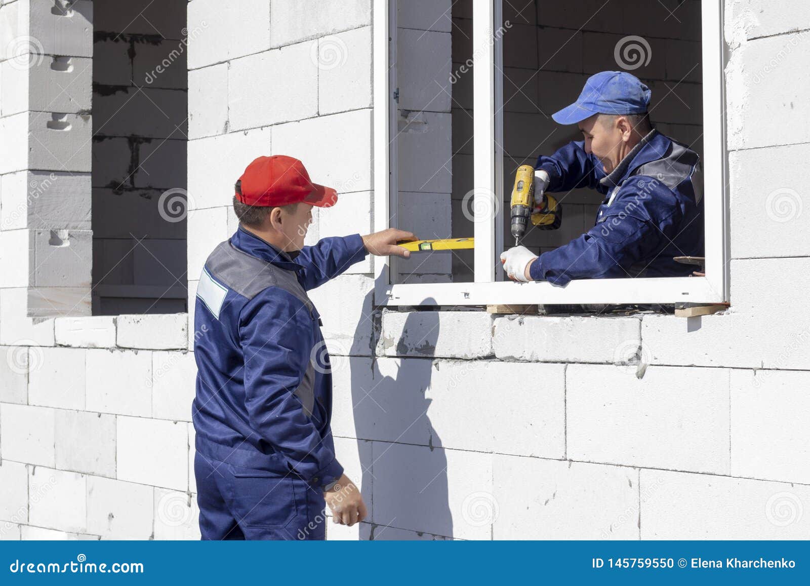 Workers Install Glazing in a House Under Construction Stock Photo ...