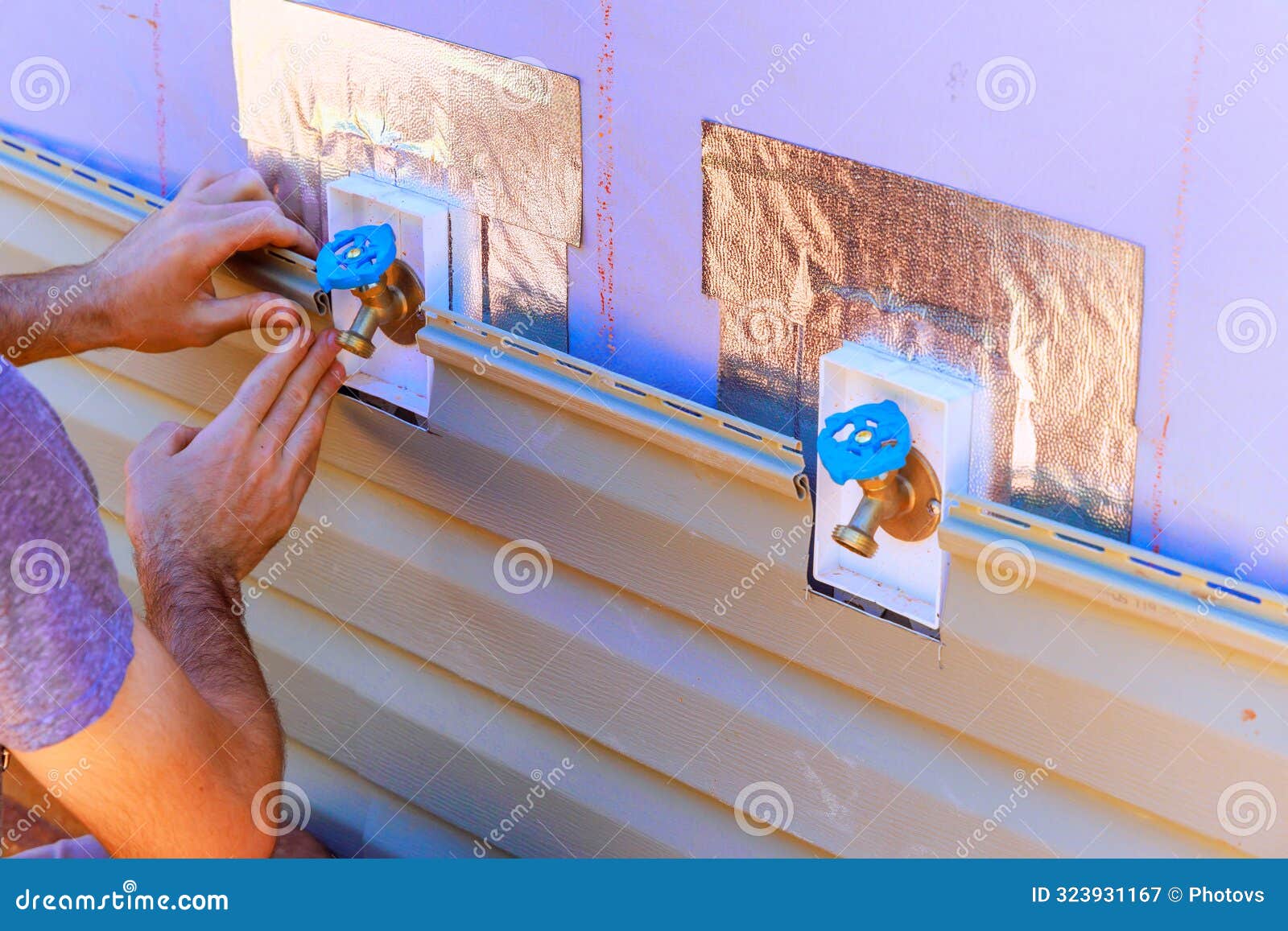 Workers Install Vinyl Plastic Siding Panels on Facade of a New Home ...