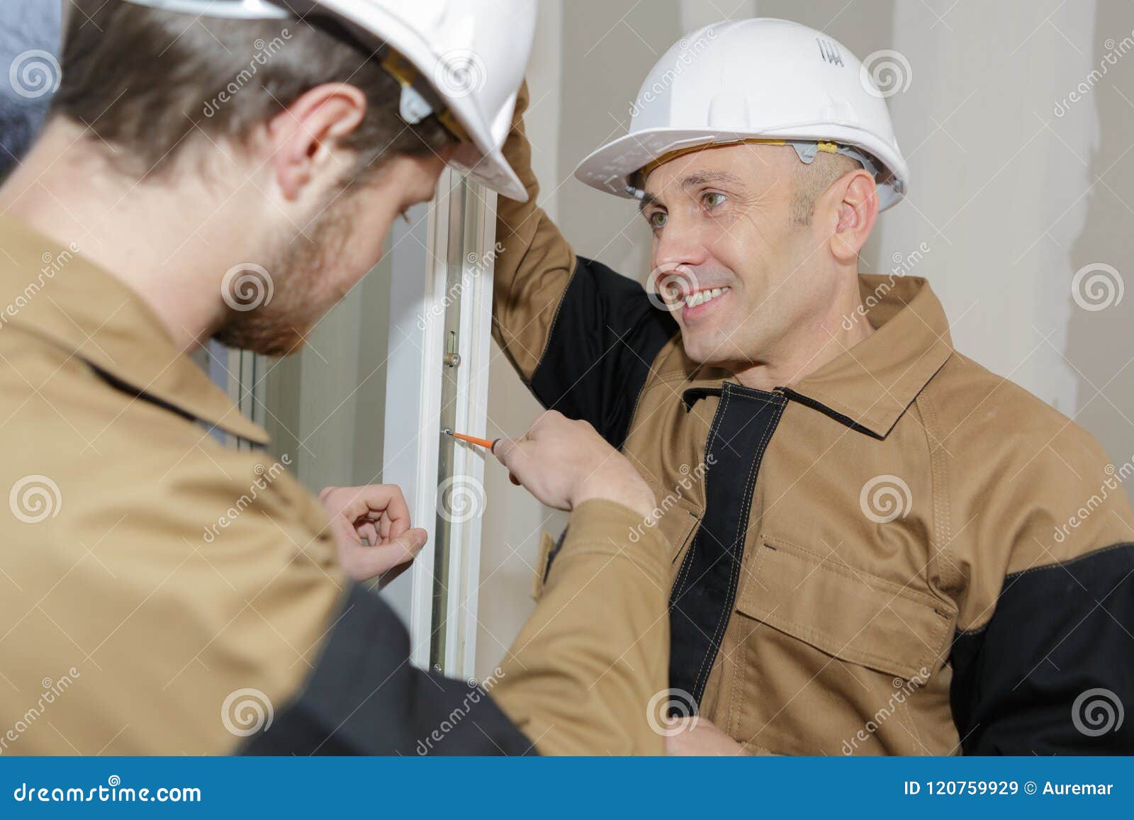 Workers installing a door stock image. Image of carpenter - 120759929
