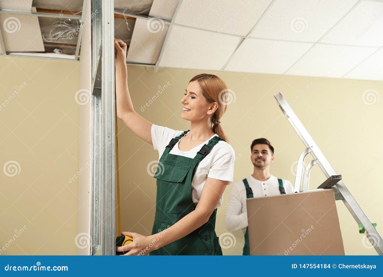 Workers Installing Drywall Indoors Stock Photo - Image of female, house ...