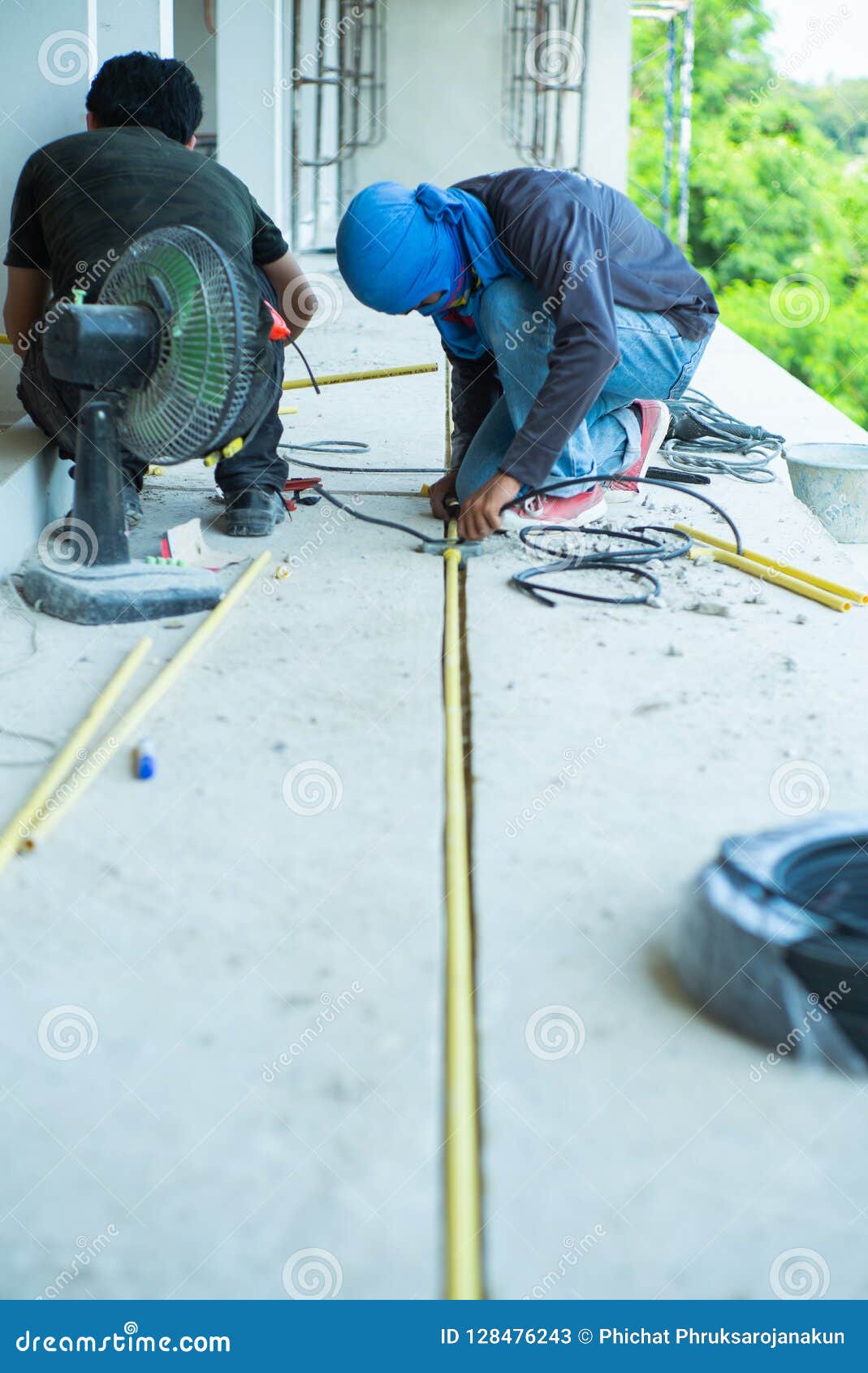 Workers Installing the Electrical Wire and Pipe in the House Under ...