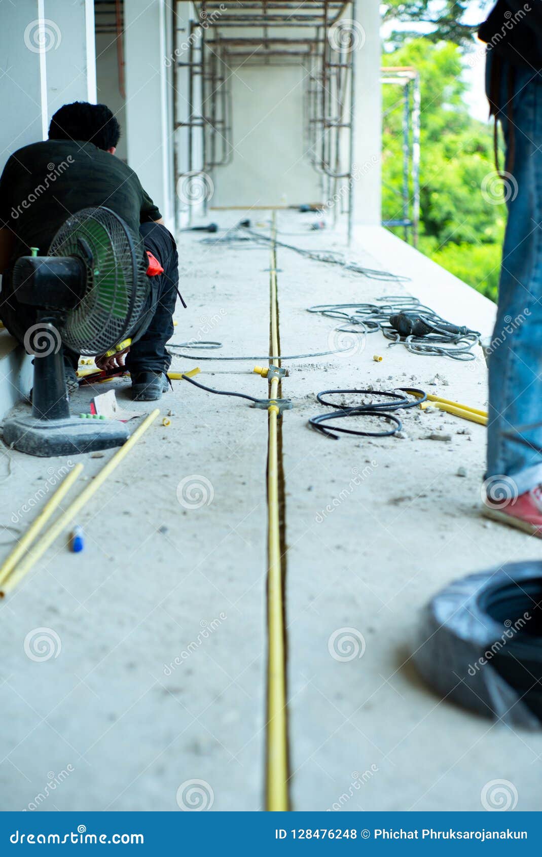Workers Installing the Electrical Wire and Pipe in the House Under ...