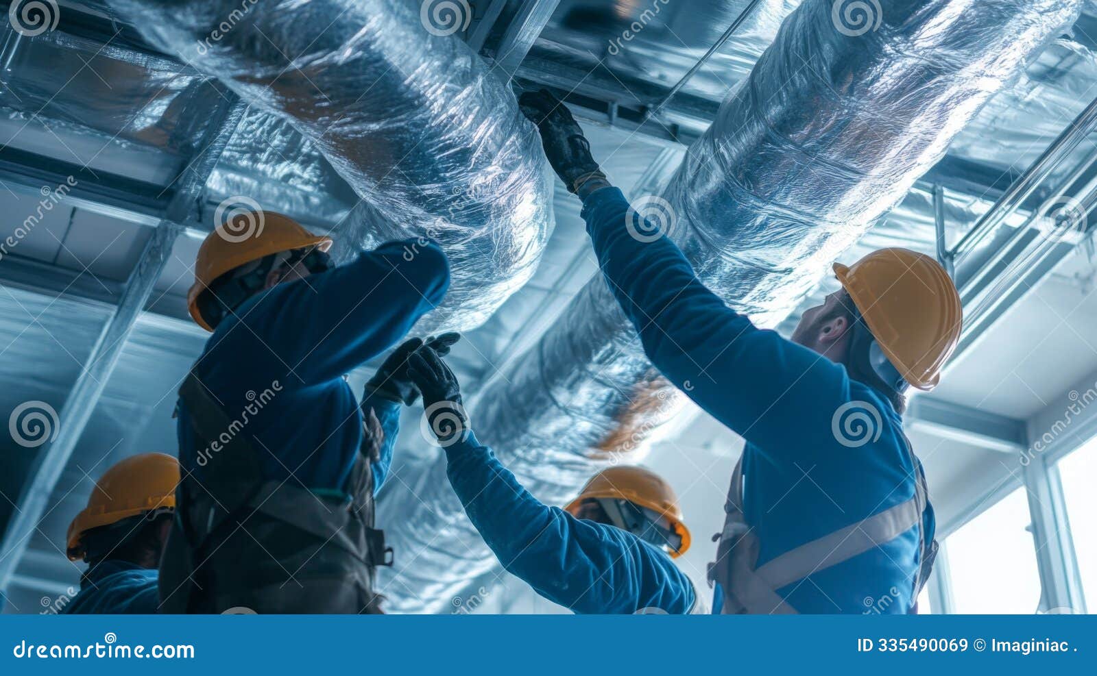 Workers Installing Insulation And Ducts In A Building Royalty-Free ...