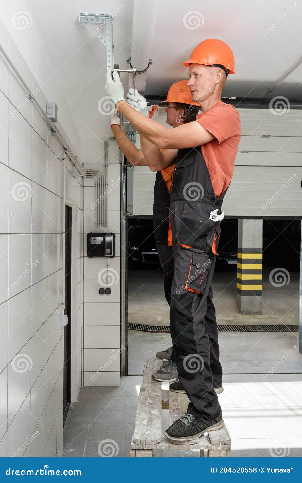 The Workers are Installing Lift Gates in the Garage Stock Photo - Image ...