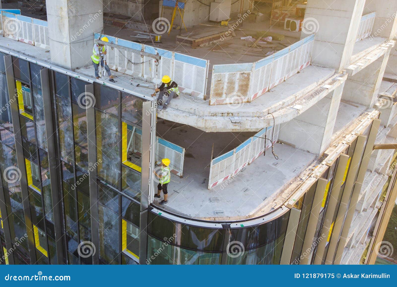 Workers Are Insulating The Wall Of A Building. Construction Site ...