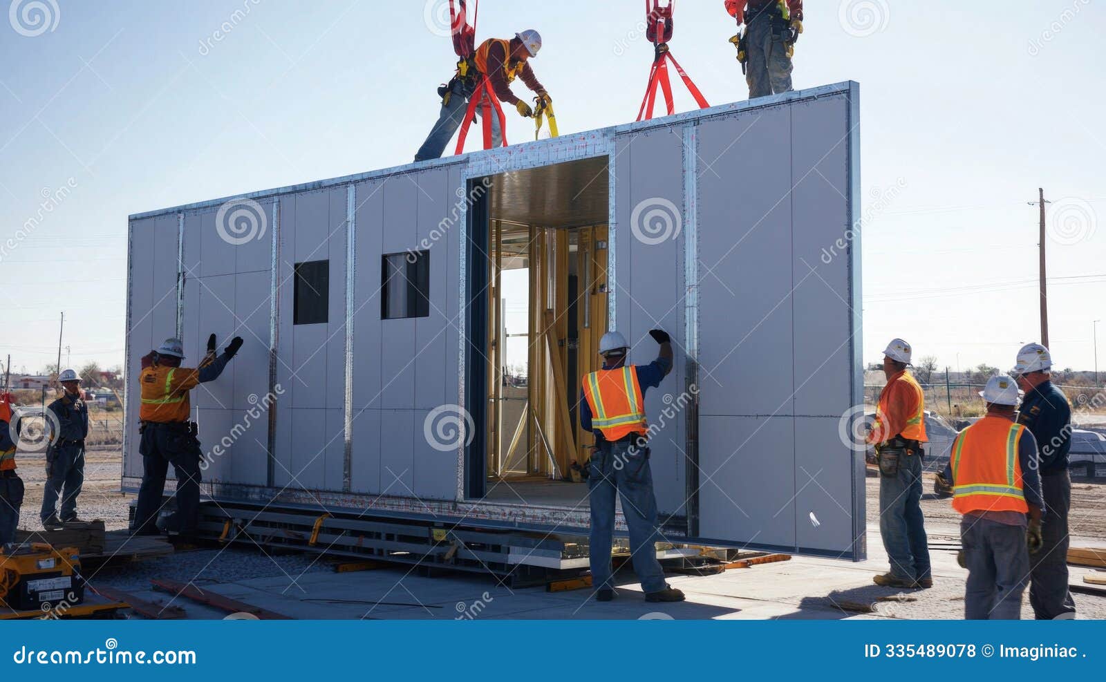 Workers Installing Prefabricated Wall Panel on a Building Under ...