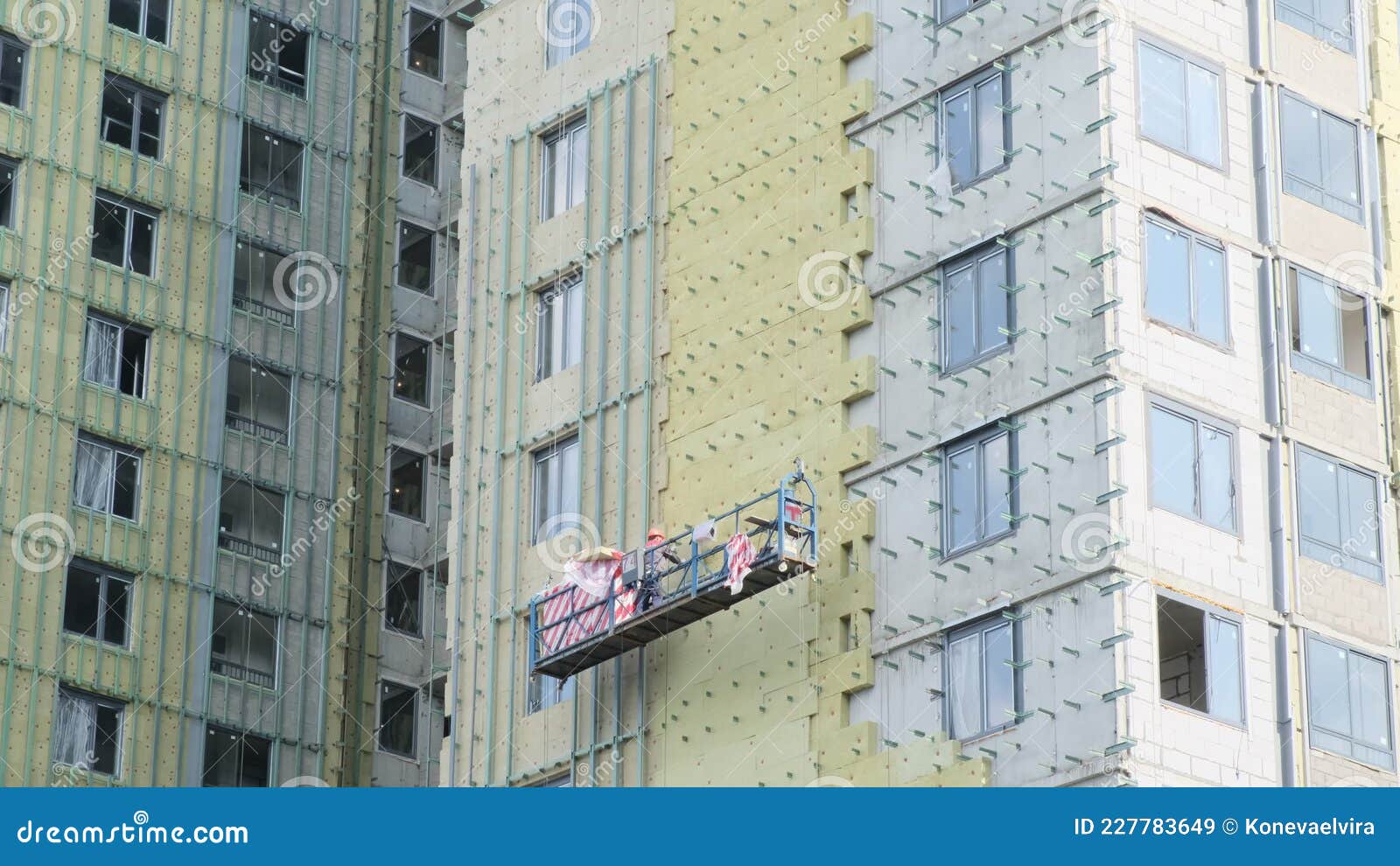 Workers are Insulating the Wall of a Building. Construction Site ...