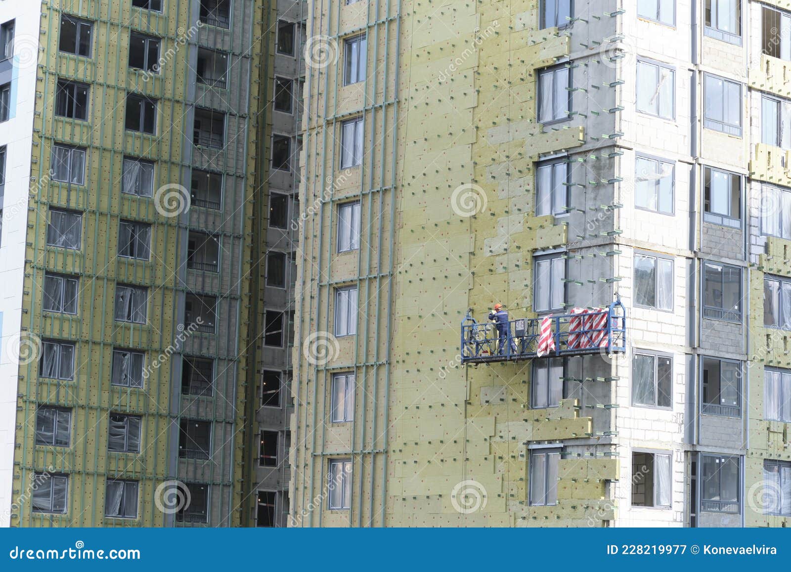 Workers are Insulating the Wall of a Building. Construction Site ...