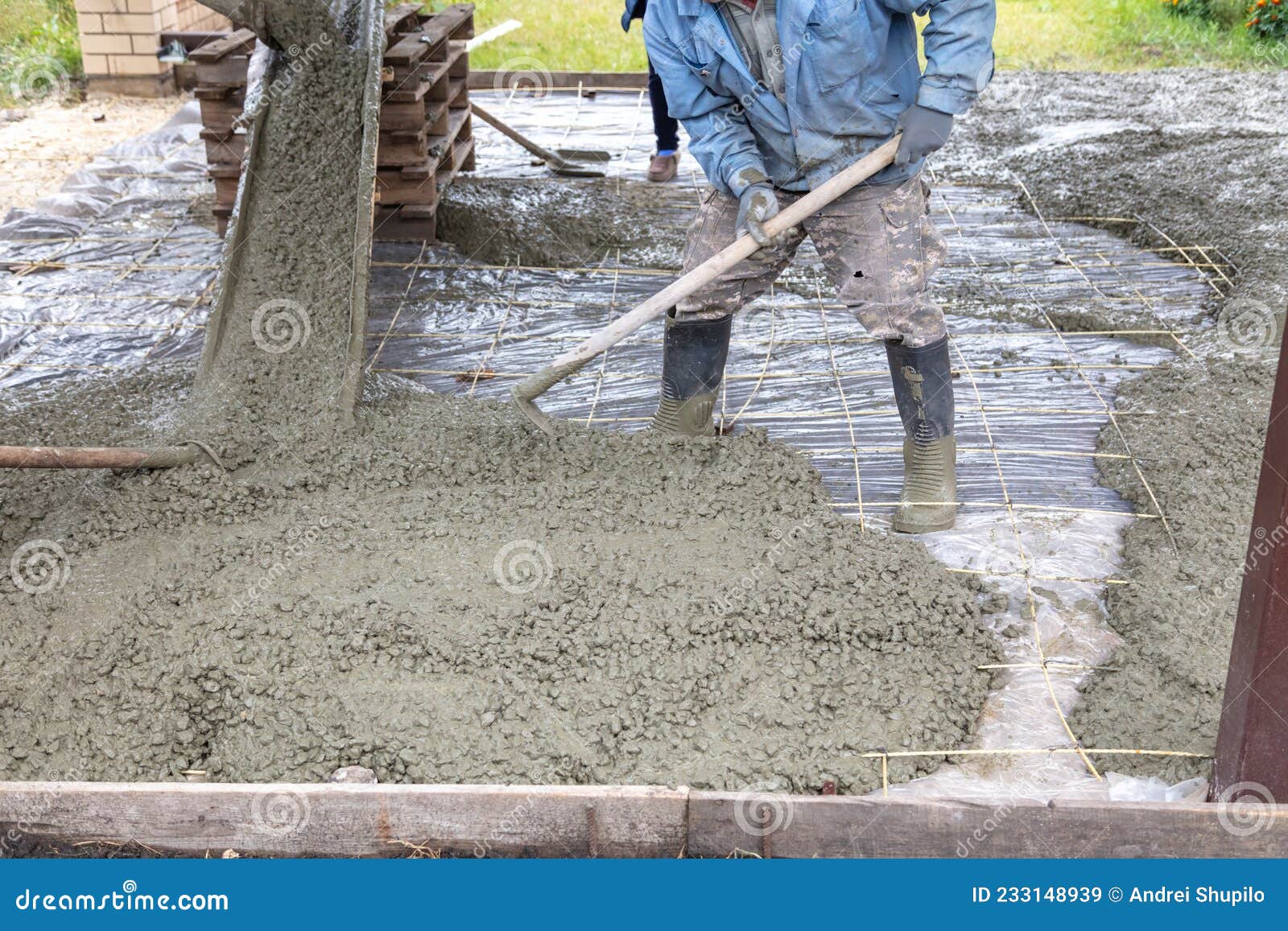 Workers Level Out the Concrete Mix at a Construction Site. Stock Image ...