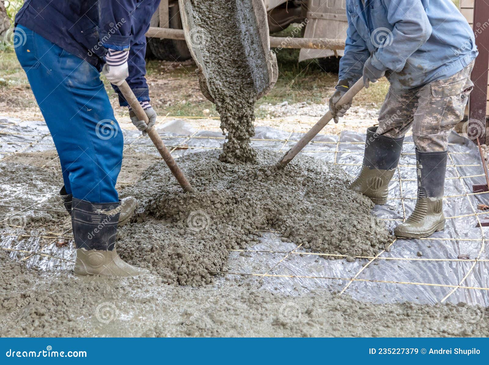 Workers Level Out the Concrete Mix at a Construction Site. Stock Image ...