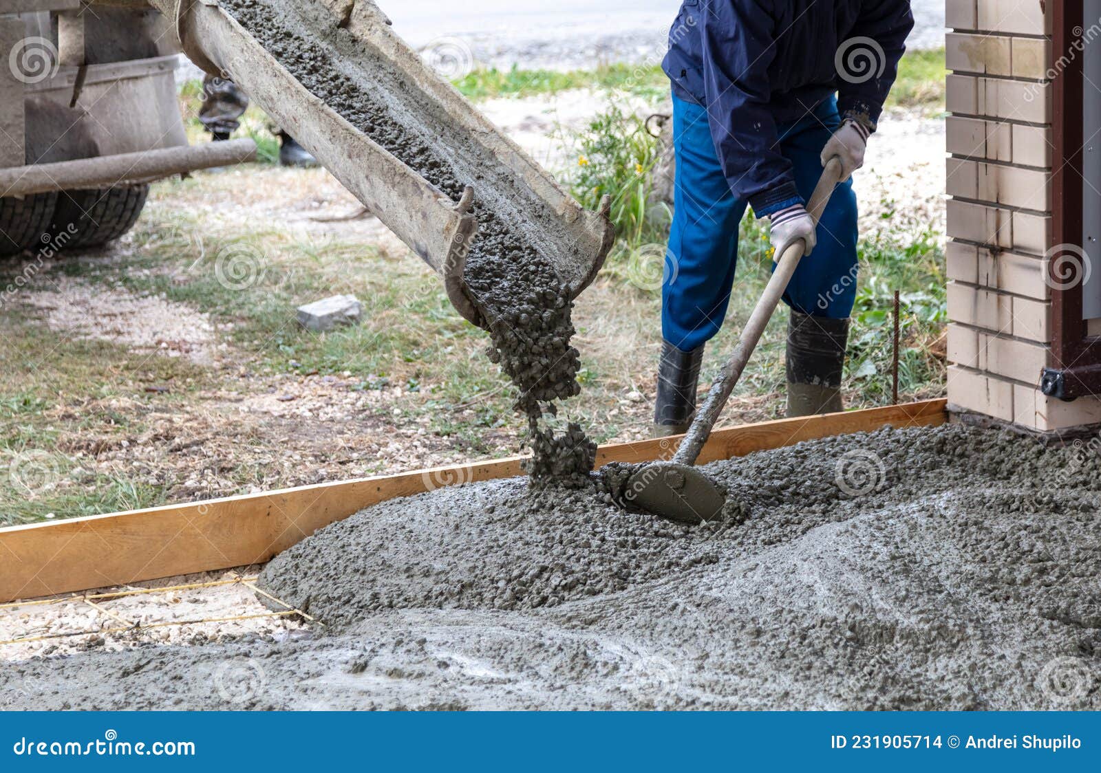 Workers Level Out the Concrete Mix at a Construction Site. Stock Photo ...