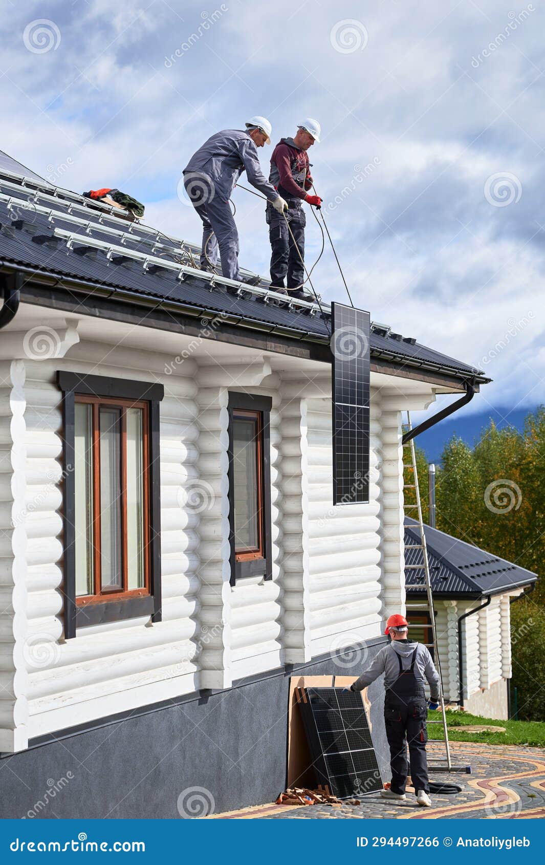 Workers Lifting Up Photovoltaic Solar Module while Installing Solar ...