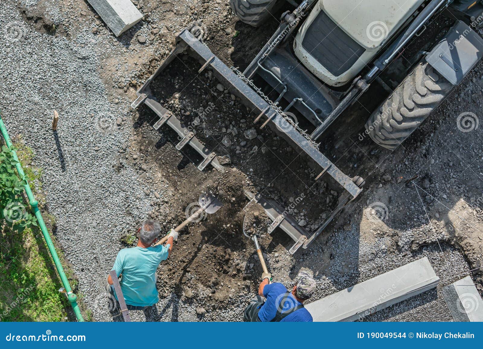 Workers Load Soil into Excavator Bucket during Road Construction ...