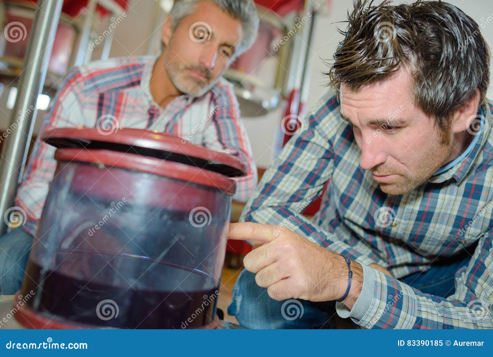 Workers looking at device stock image. Image of fixing - 83390185