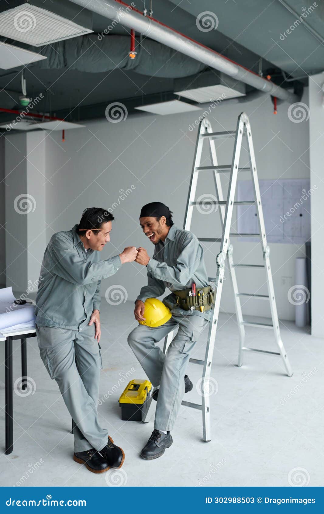 Workers Making Fist Bump stock image. Image of builder - 302988503