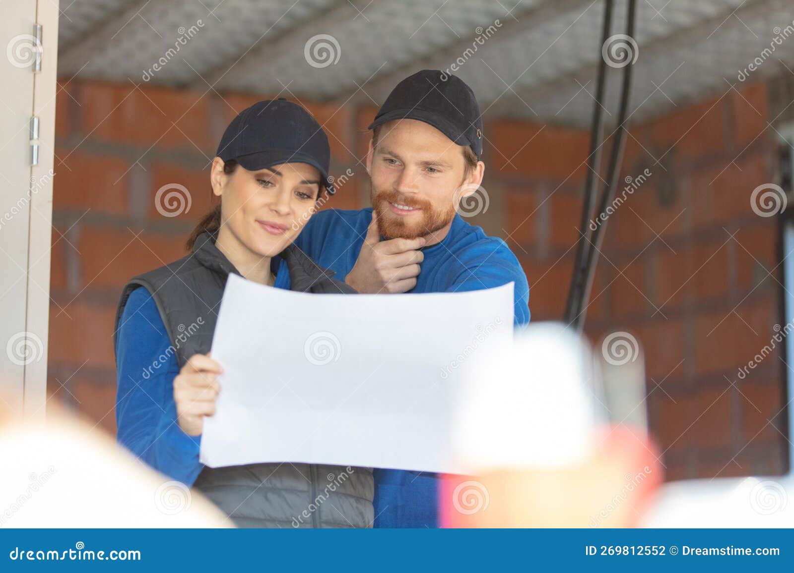 Workers Man and Woman Discuss Construction Plan Stock Photo - Image of ...