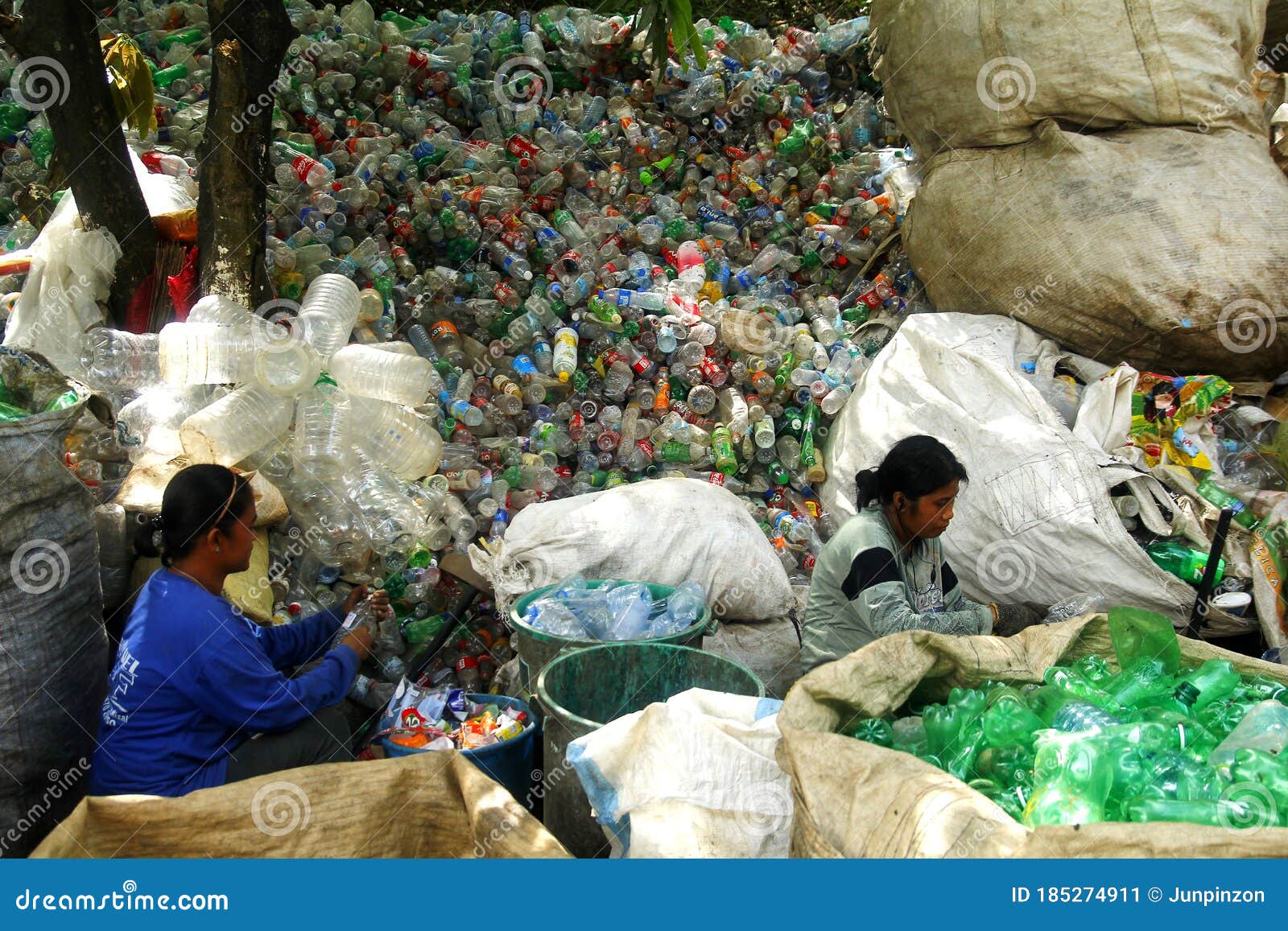 Workers Of A Materials Recovery Facility Prepare Plastic Bottles For ...