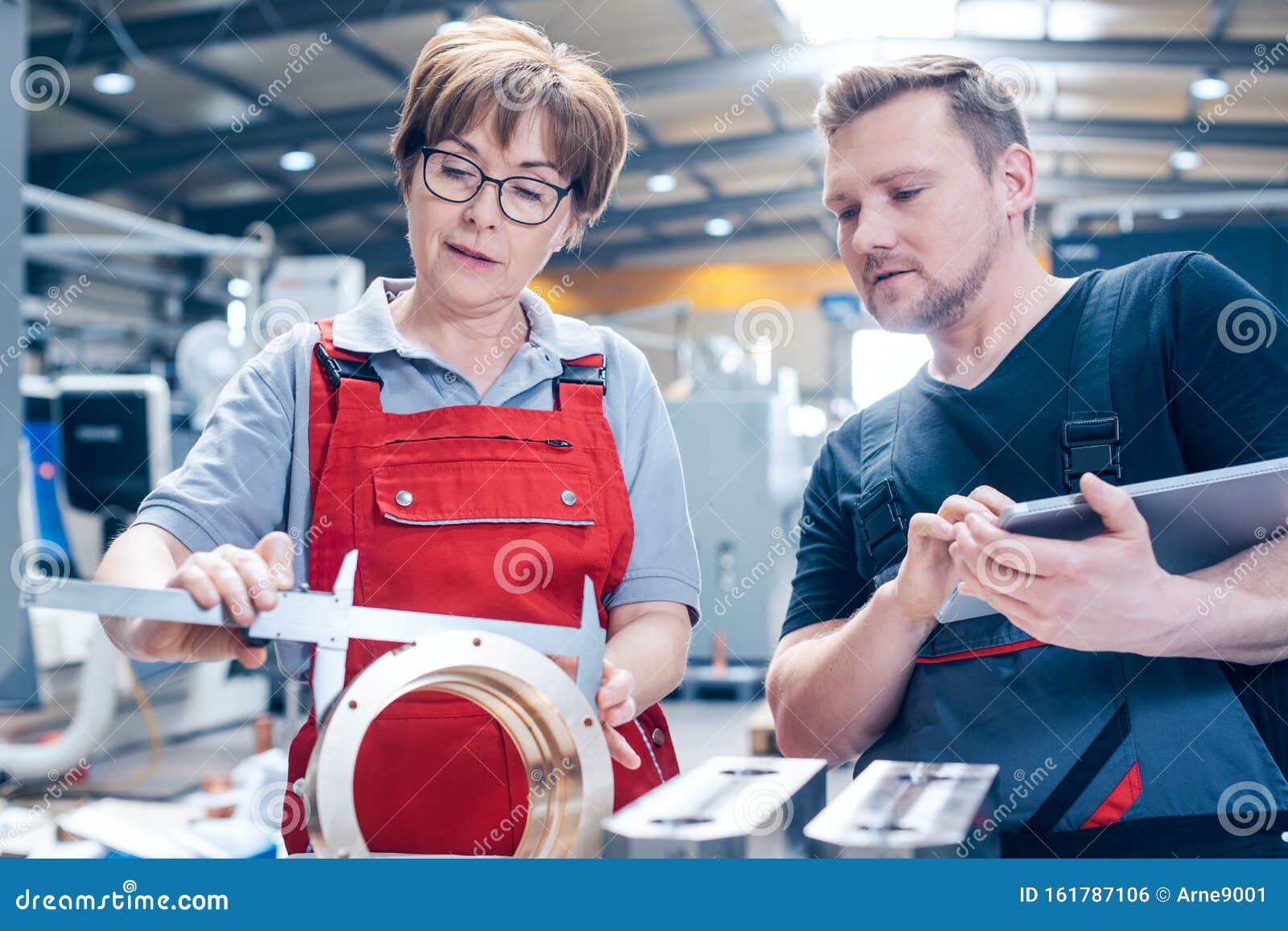 Workers Measuring a Metal Workpiece Stock Photo - Image of people ...