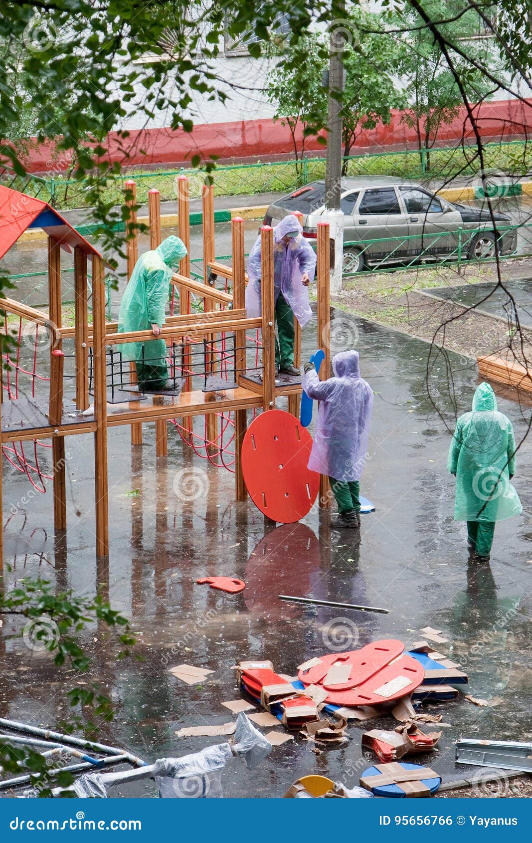 Workers in Multi-colored Rain Capes Work on the Playground. Editorial ...