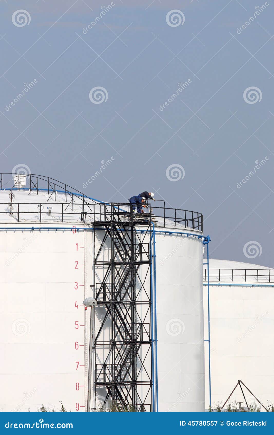 Workers on oil tank stock image. Image of container, cloud - 45780557
