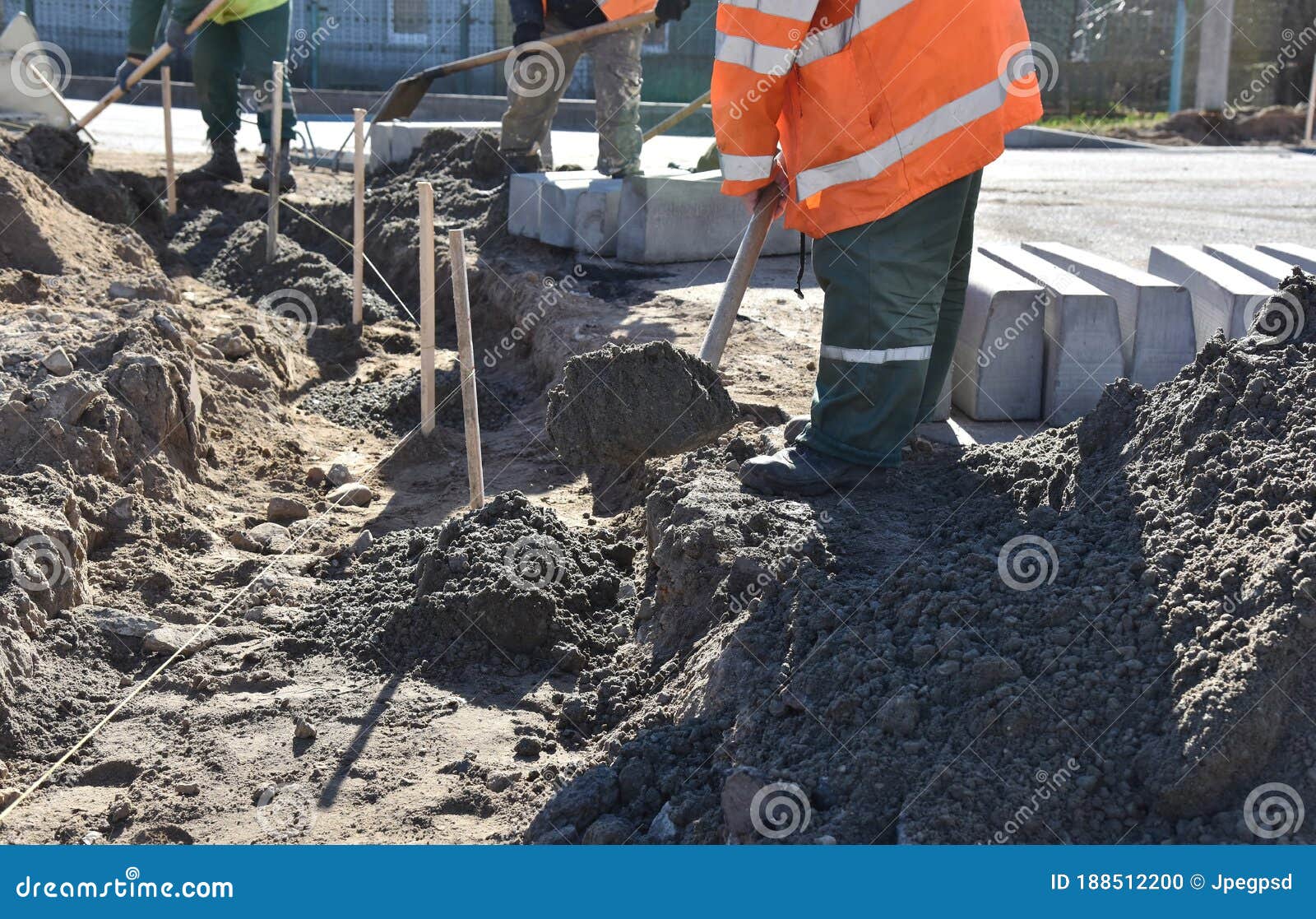 Workers in Overalls Throw Cement into the Pit. Stock Photo - Image of ...