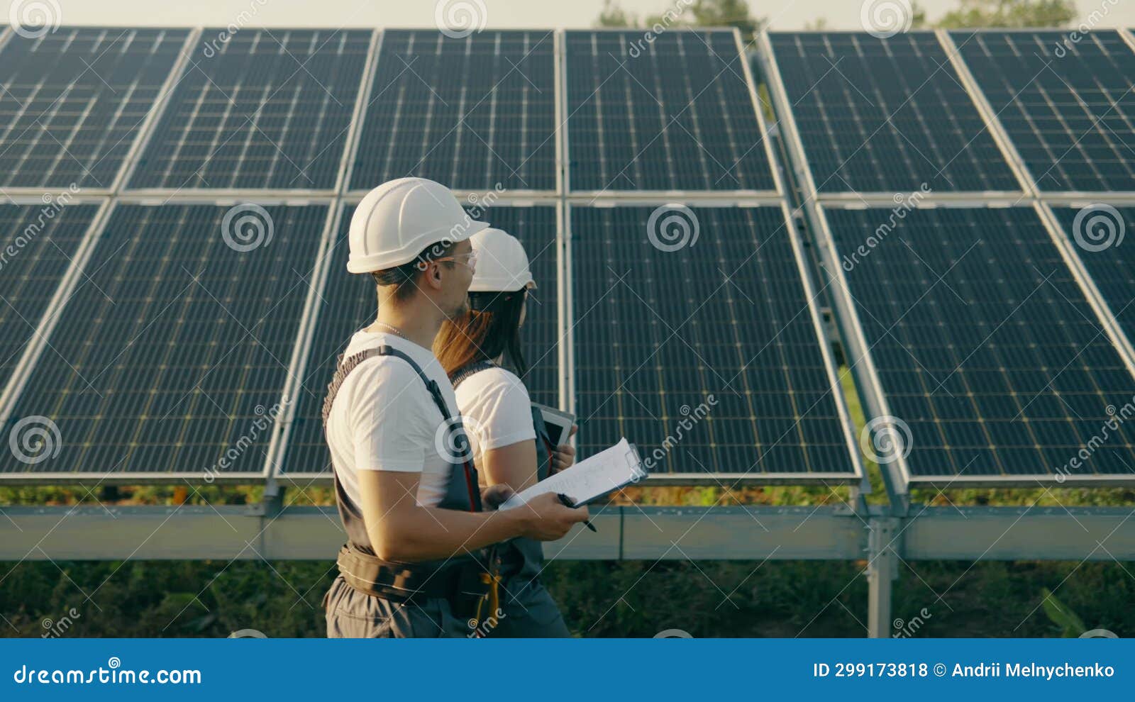 Workers in Overalls Walk Around the Solar Panel Area and Analyze Data ...