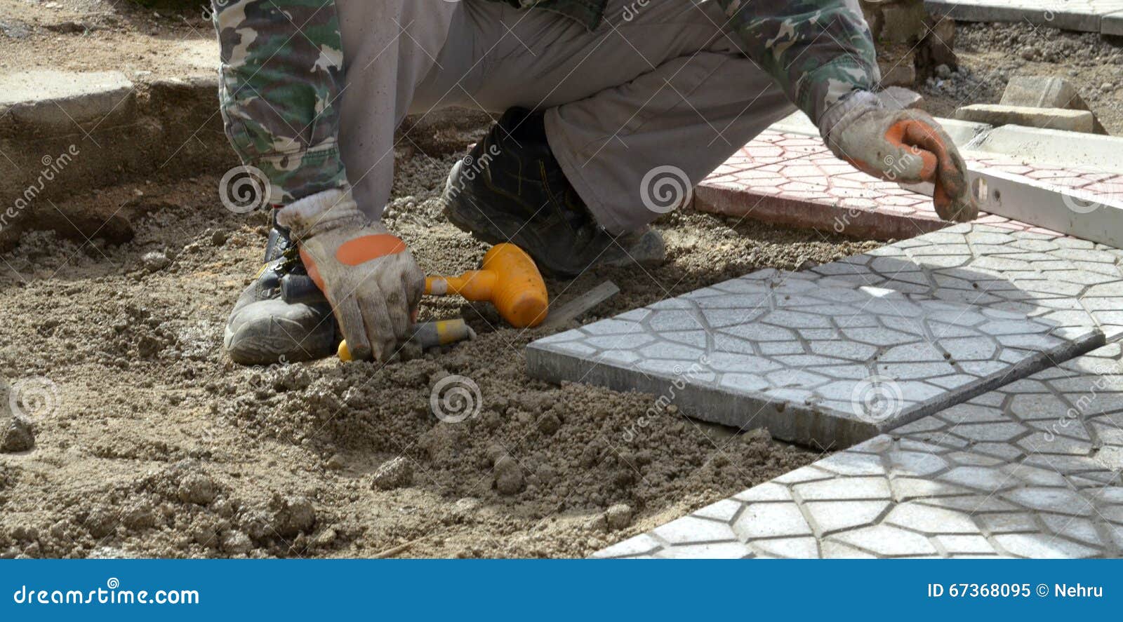 Workers paving walkway stock image. Image of construction - 67368095
