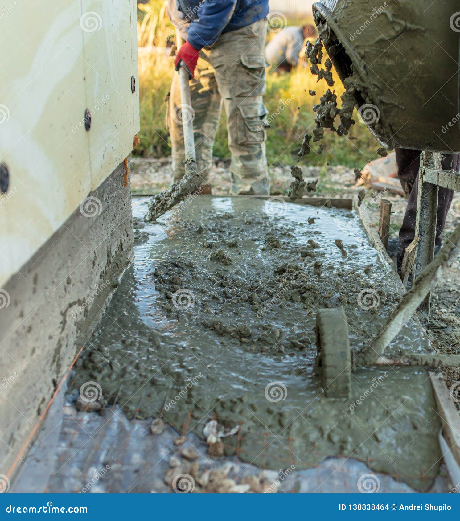 Workers Pour Concrete Solution at a Construction Site Stock Photo ...