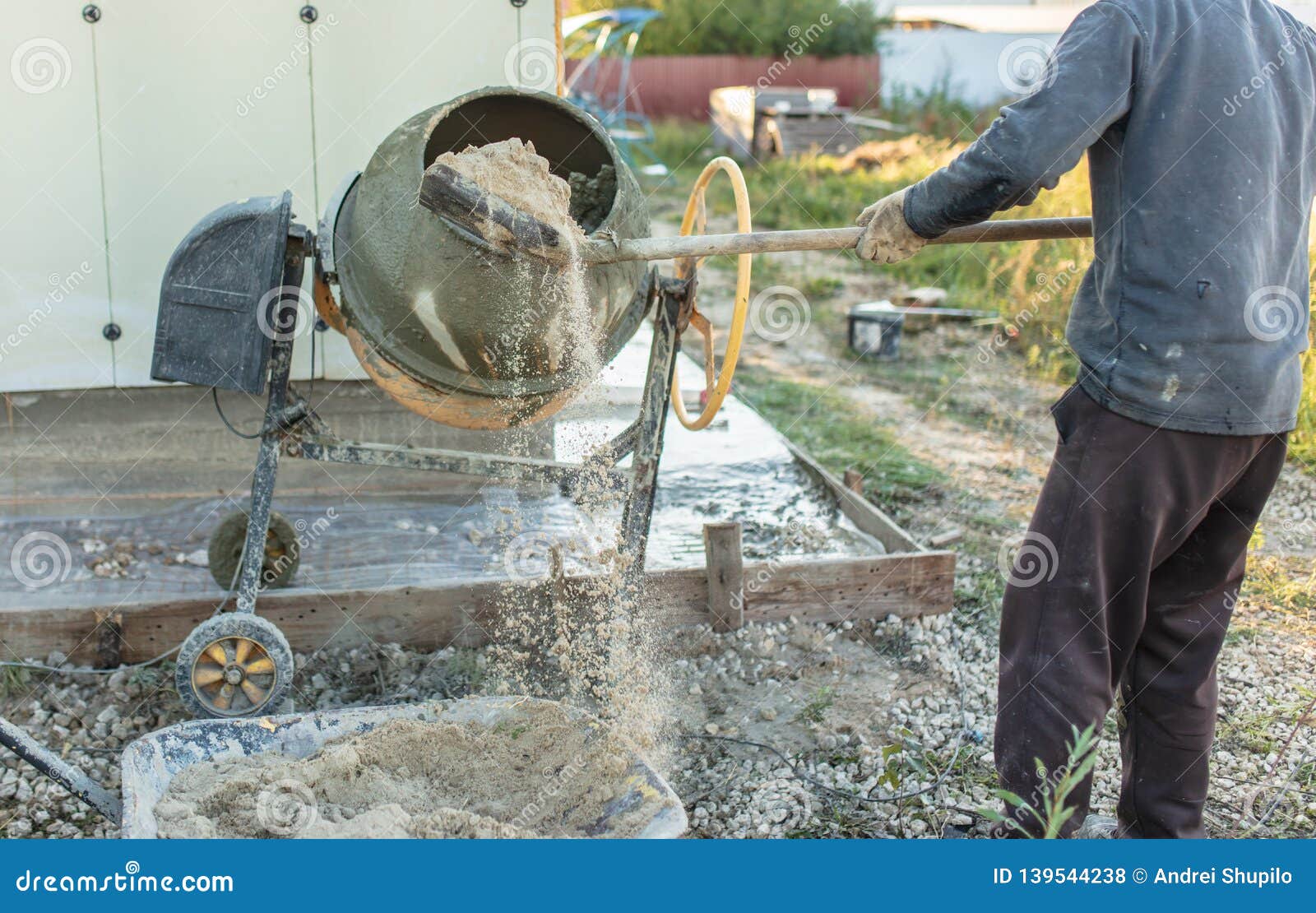 Workers Pour Concrete Solution at a Construction Site Stock Photo ...