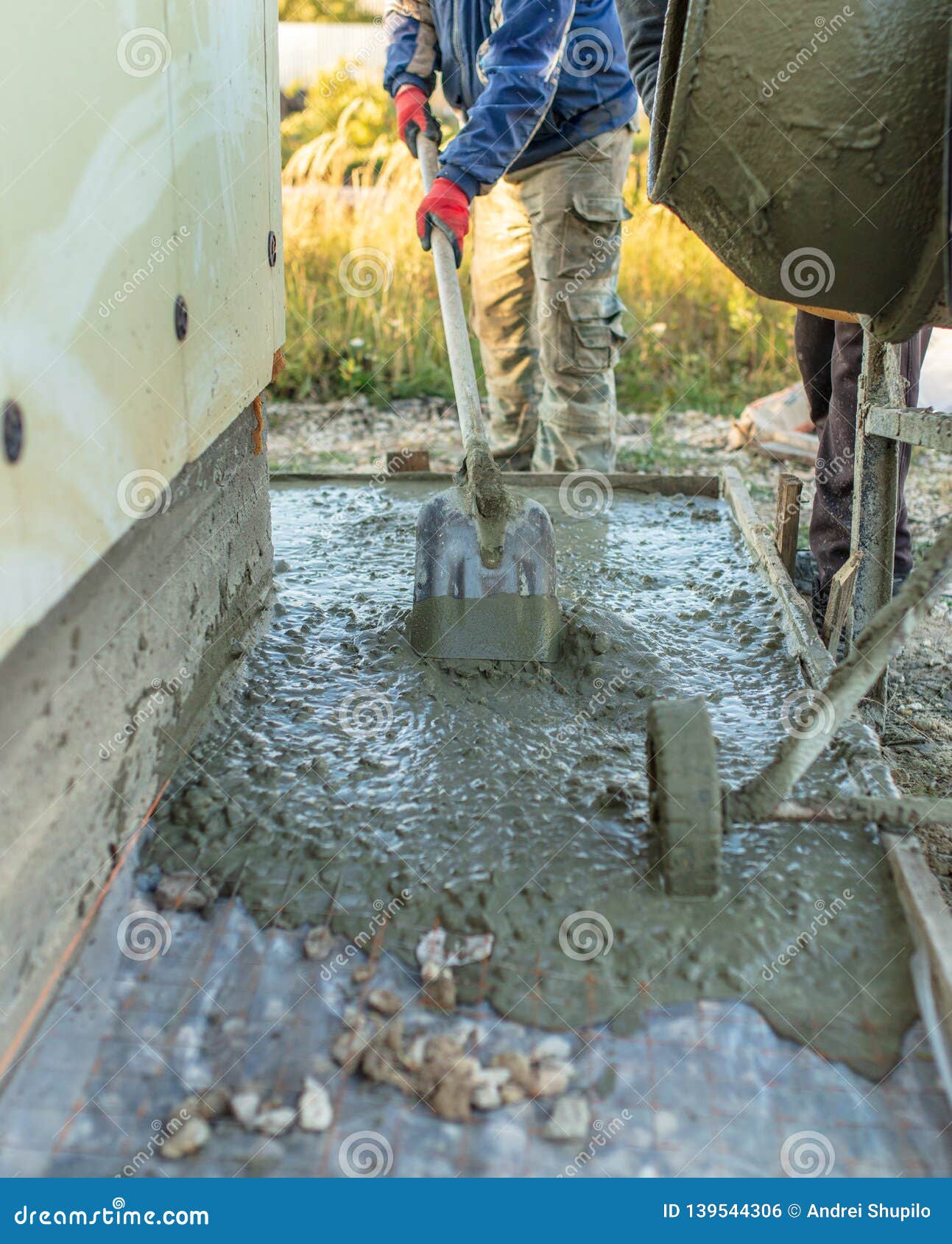 Workers Pour Concrete Solution at a Construction Site Stock Photo ...