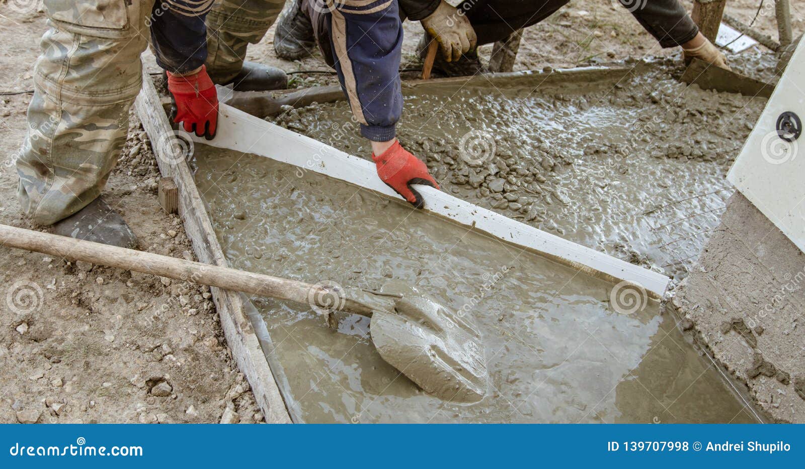 Workers Pour Concrete Solution at a Construction Site Stock Photo ...