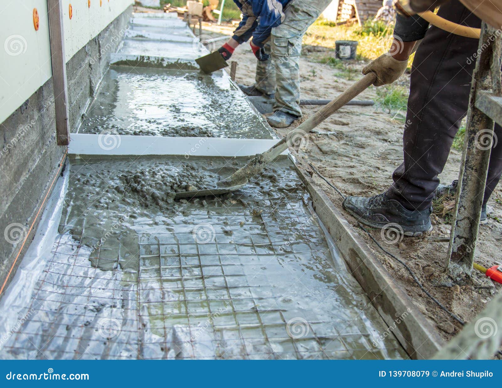 Workers Pour Concrete Solution at a Construction Site Stock Image ...