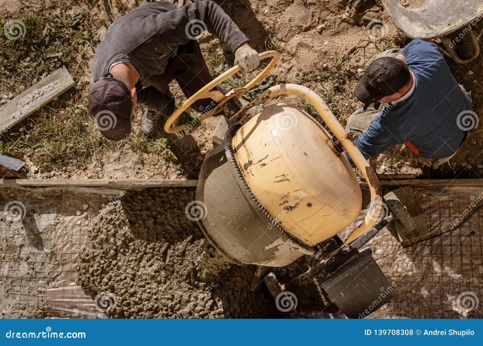 Workers Pour Concrete Solution at a Construction Site Stock Photo ...