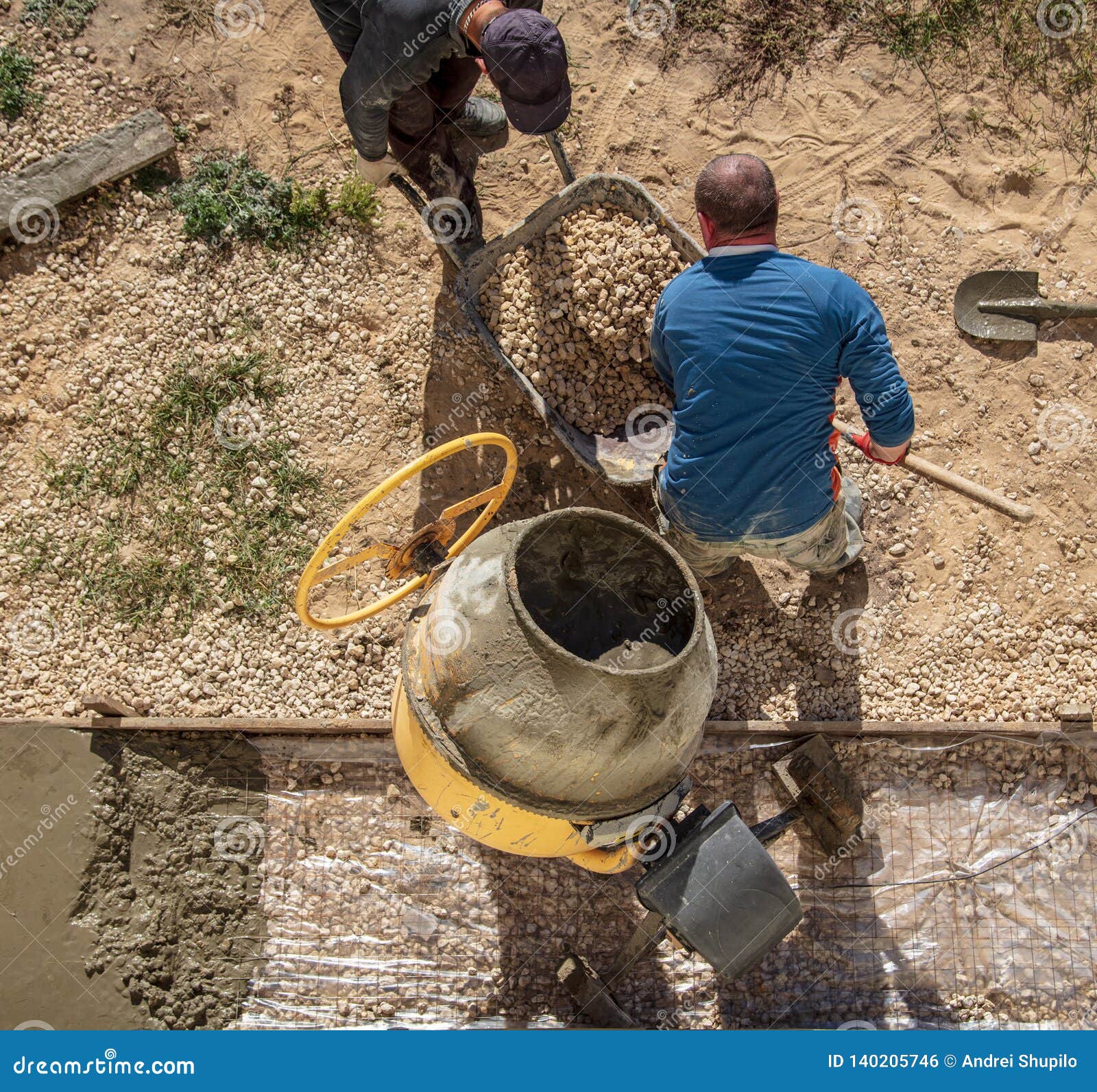 Workers Pour Concrete Solution at a Construction Site Stock Photo ...