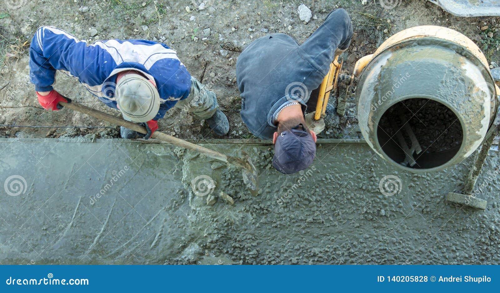 Workers Pour Concrete Solution at a Construction Site Stock Photo ...