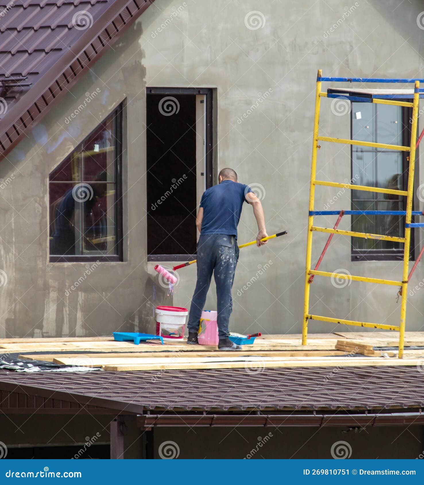 Workers are Priming Outside the Walls of the House. Stock Image - Image ...