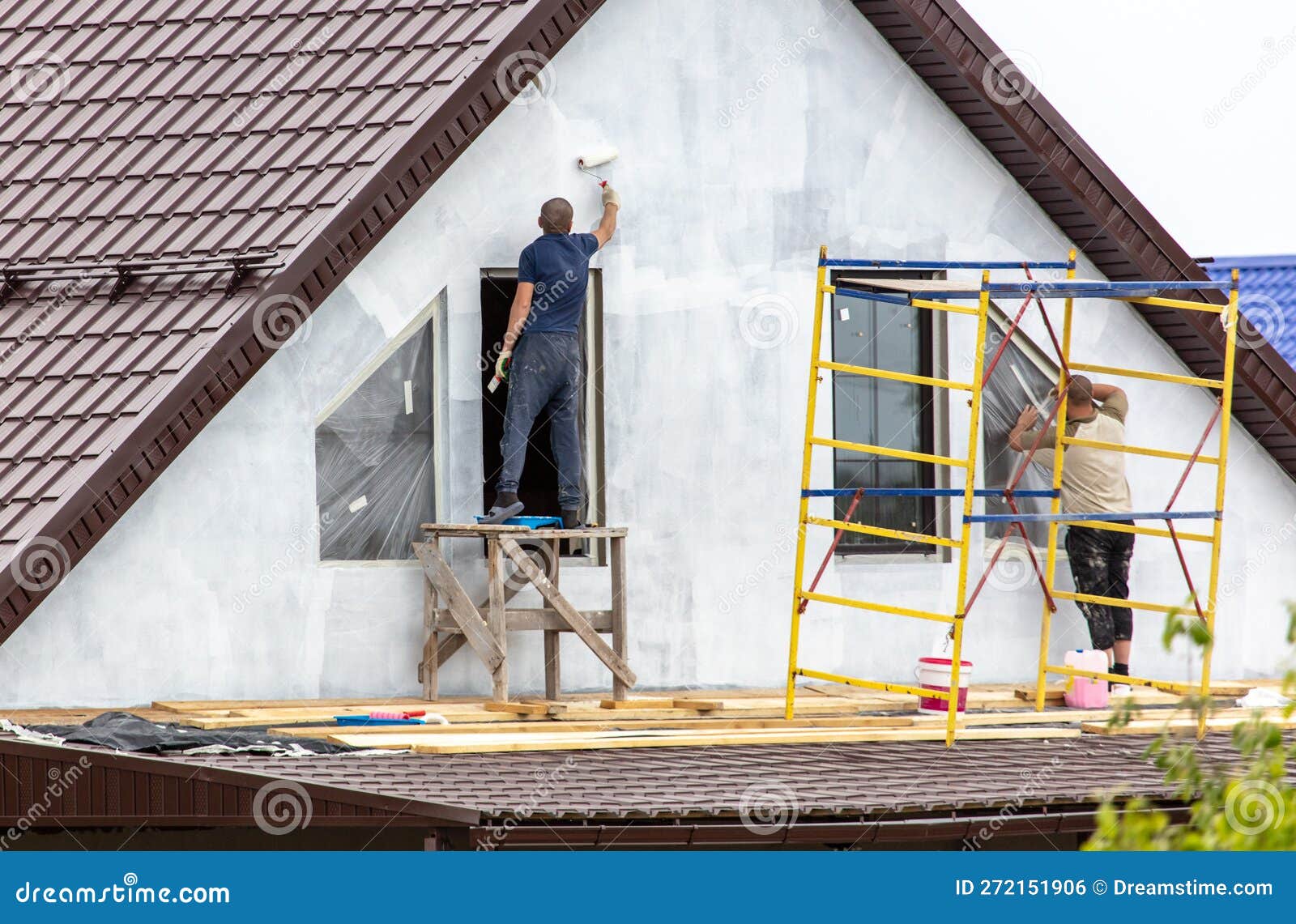 Workers are Priming Outside the Walls of the House. Editorial Photo ...