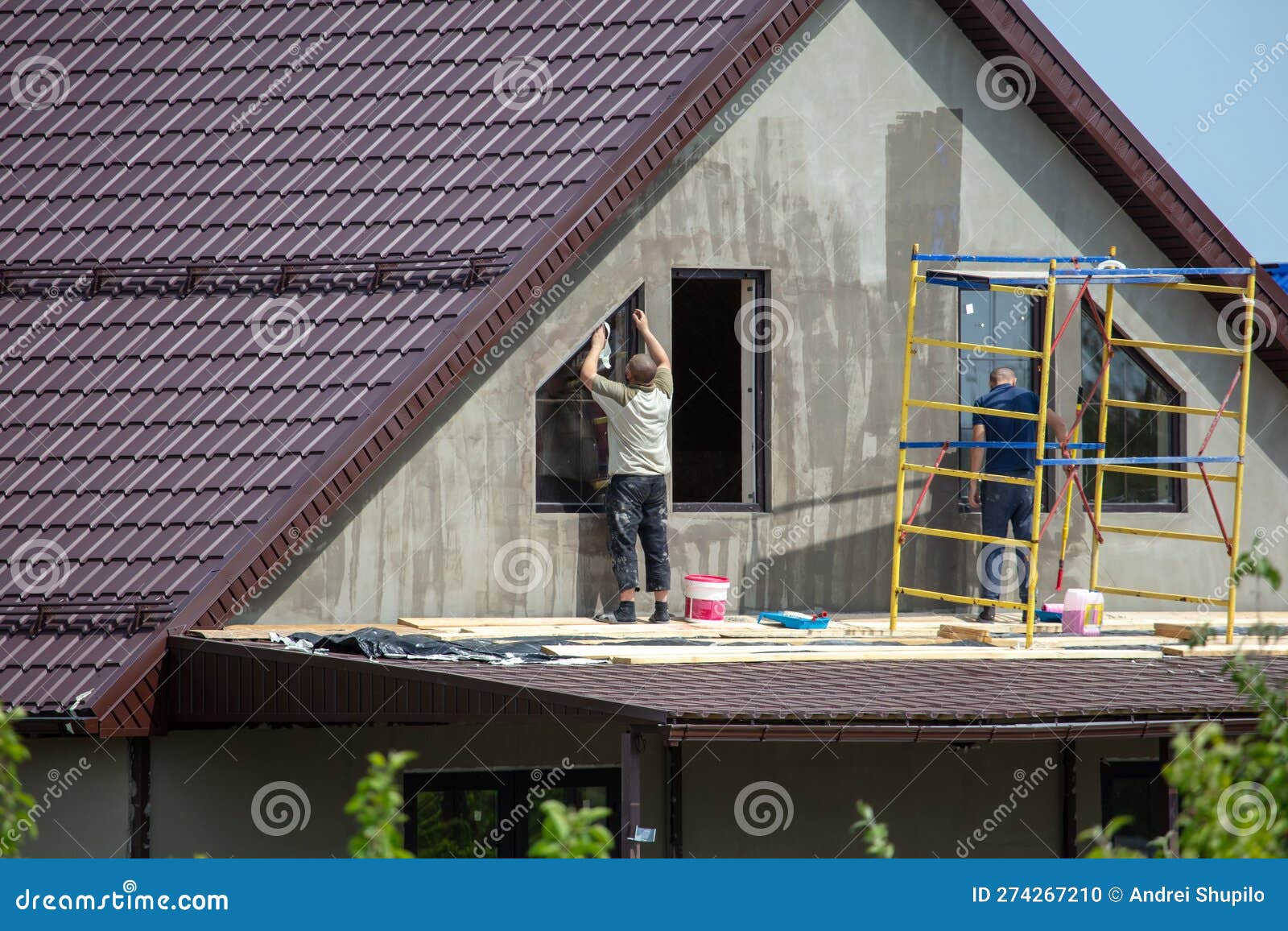 Workers are Priming Outside the Walls of the House. Stock Photo - Image ...
