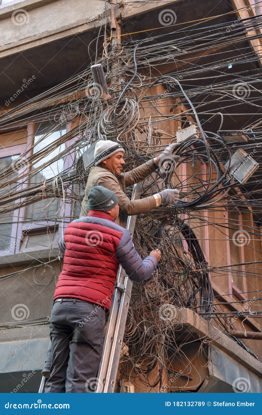 Workers Reparing a Multitude of Entangled Electrical Cables at ...