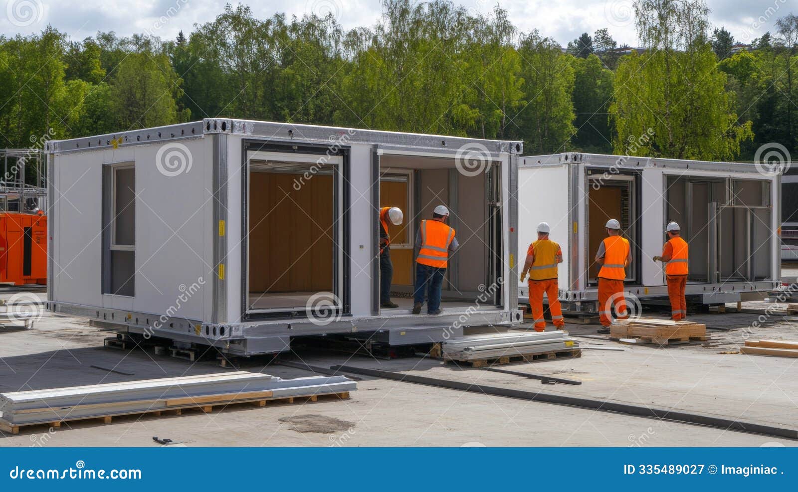 Workers in Safety Vests Inspecting Pre-Fabricated Modular Home Units ...