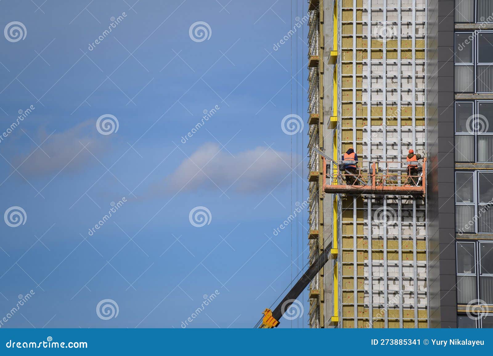 Workers Sheathe the Outer Walls of the Building with Insulation ...
