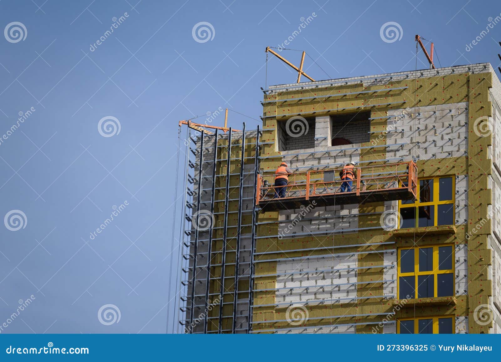 Workers Sheathe the Outer Walls of the Building with Insulation ...