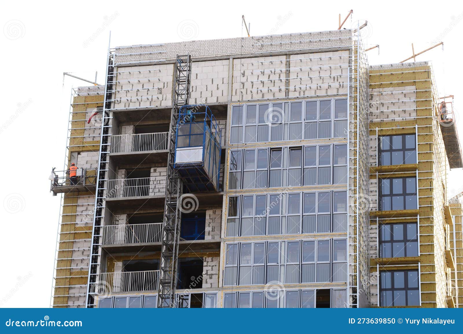 Workers Sheathe the Outer Walls of the Building with Insulation ...