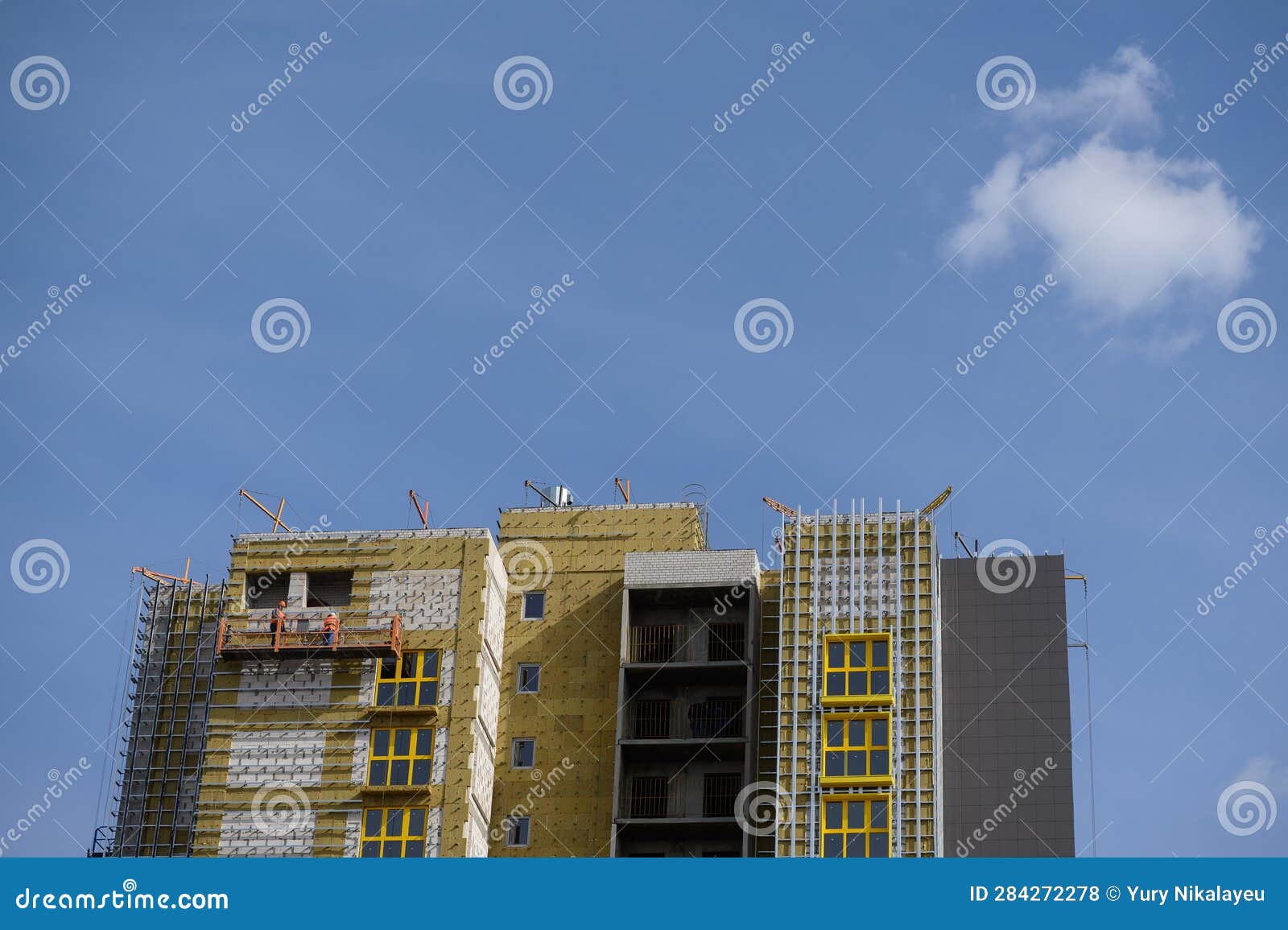 Workers Sheathe the Outer Walls of the Building with Insulation ...