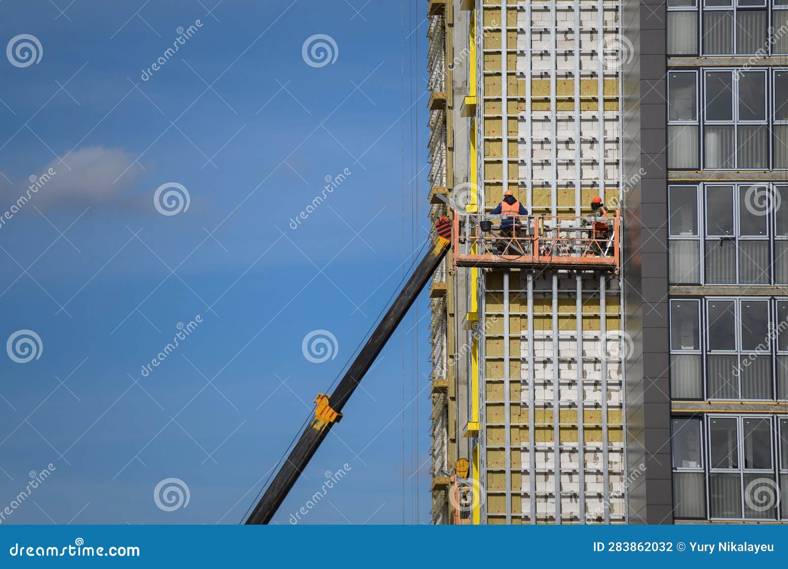 Workers Sheathe the Outer Walls of the House with Insulation ...