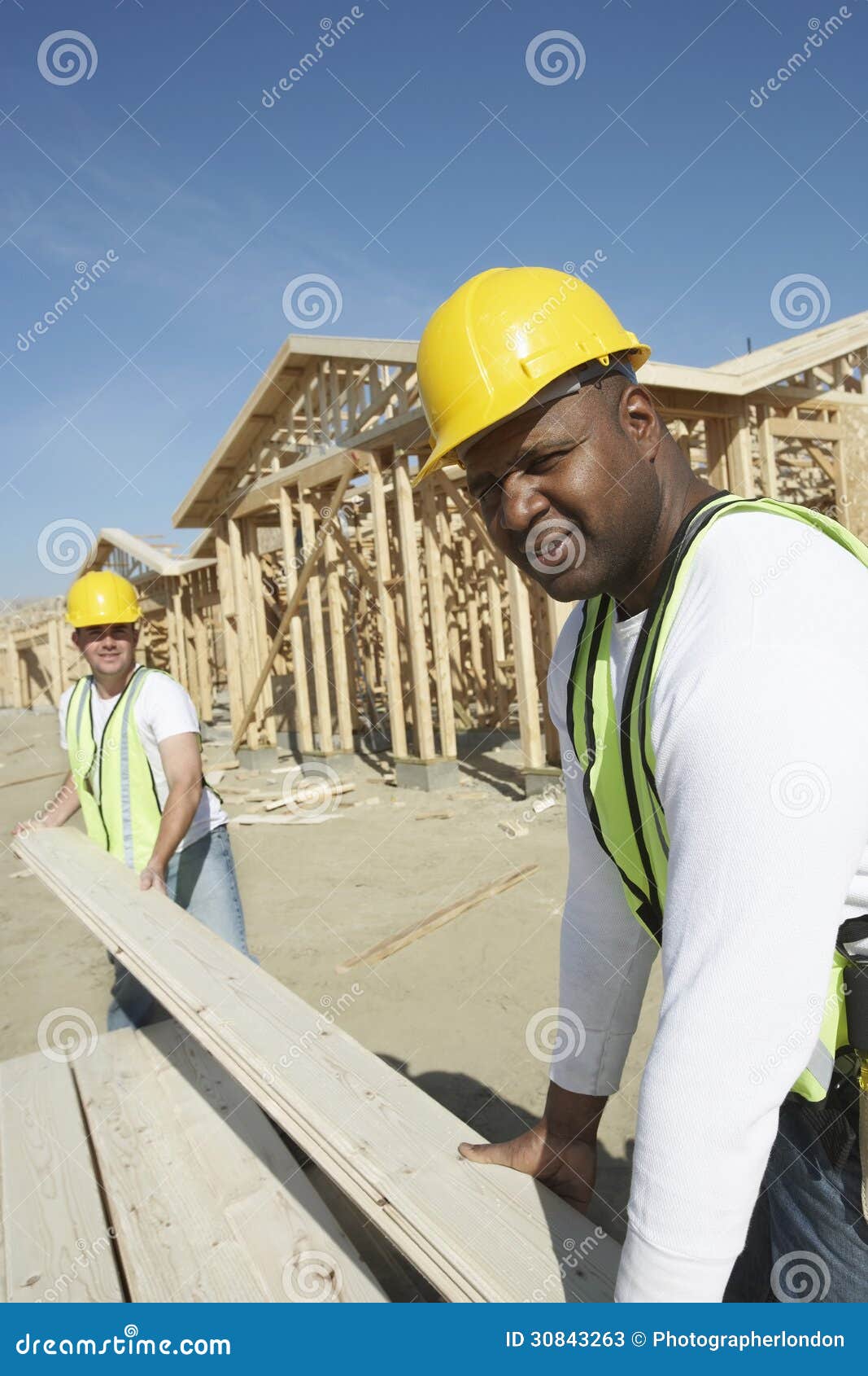 Workers Stacking Boards at Construction Site Stock Image - Image of ...