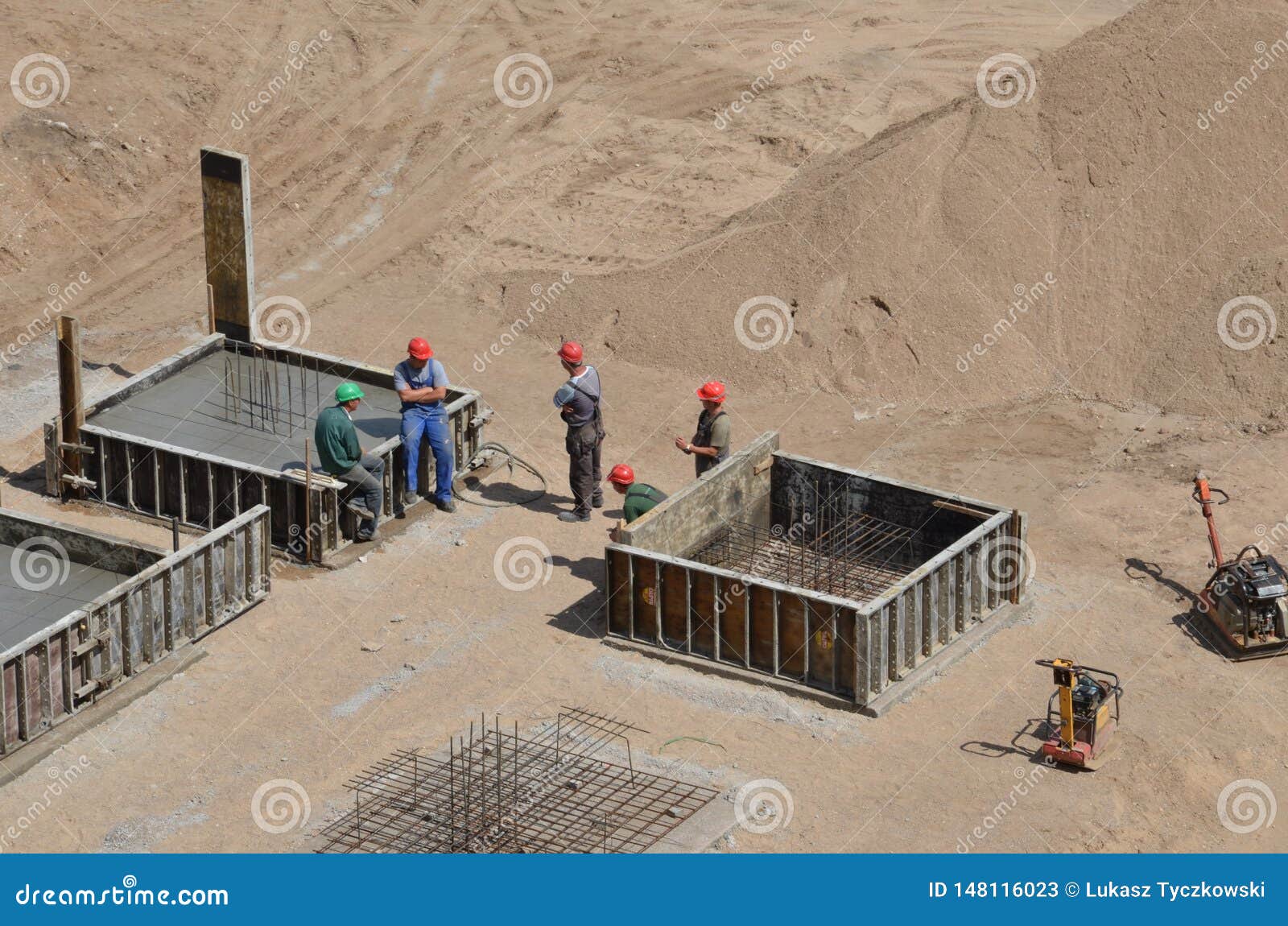Workers Standing at Construction Site Having a Conversation during ...