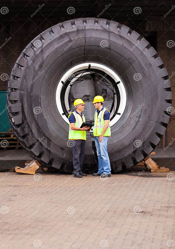 Workers standing tire stock photo. Image of adult, helmet - 31711696