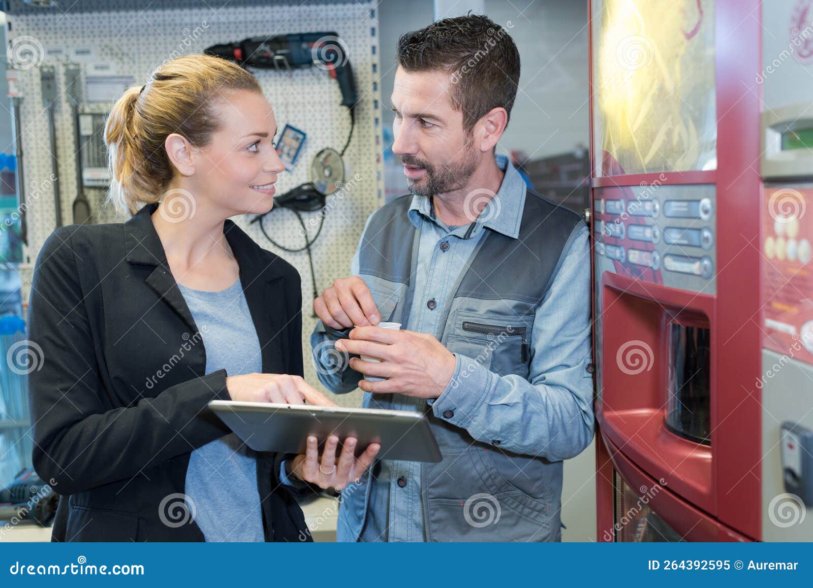 Workers Stood by Vending Machine Looking at Tablet Stock Image - Image ...